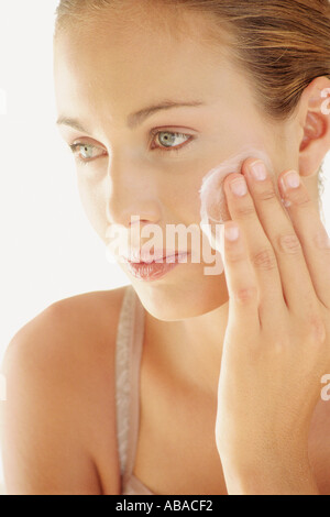 Woman Applying Face Mask Stock Photo - Alamy