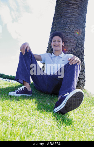 Man leaning against a tree Stock Photo - Alamy
