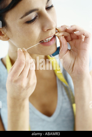 Measuring tapes and thread with needle Stock Photo - Alamy