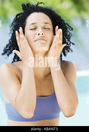 Woman with hands on side of face Stock Photo - Alamy