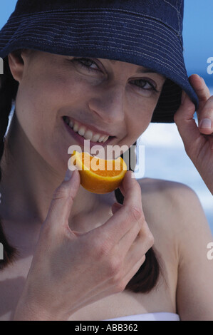 Young Woman Eating Orange Segment Model Released Stock Photo - Alamy