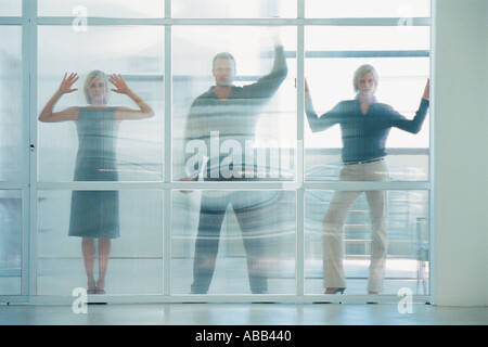Young businessman behind glass pane in office Stock Photo - Alamy