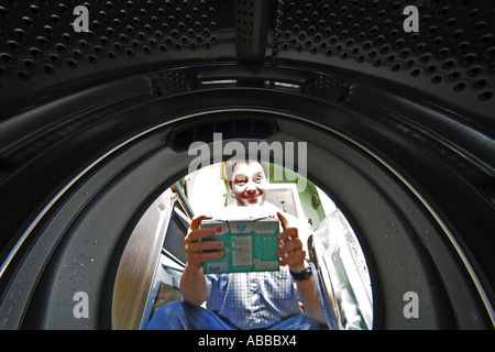 Unusual angle conceptual image shown from inside a washing machine ...