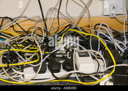 a tangle of computer wires underneath a desk in a workplace Stock Photo ...