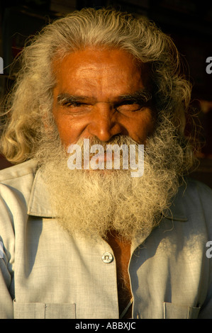 Man smiling with long gray beard while holding taco at restaurant Stock ...
