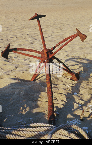 Anchor and rope laying on beach Stock Photo - Alamy