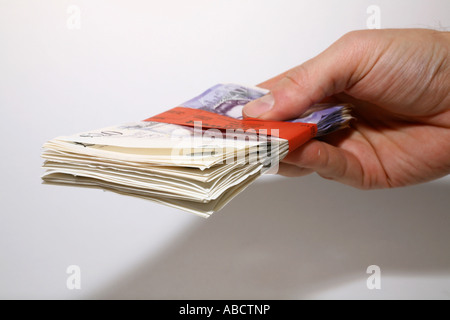 Man with bundle of Twenty pound notes Stock Photo - Alamy