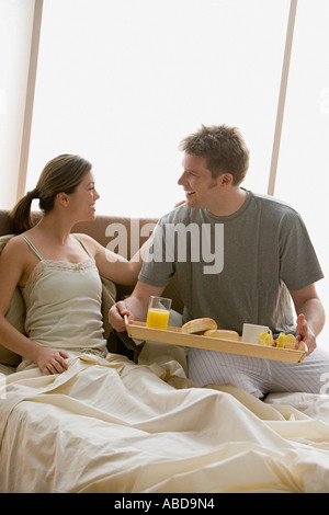 Treat your wife with breakfast in bed. a senior couple having breakfast ...