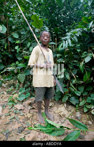 Pygmy man with spear about to go hunting in the rainforest in the ...