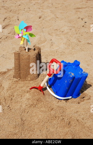sandcastle spade bucket and windmill on beach kent Stock Photo - Alamy