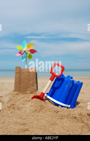 sandcastle spade bucket and windmill on beach kent Stock Photo - Alamy