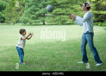 Two boys play catch throwing ball Stock Photo - Alamy