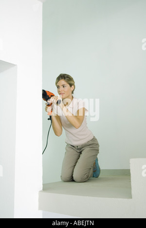 woman using a power drill drill bit towards camera Stock Photo - Alamy