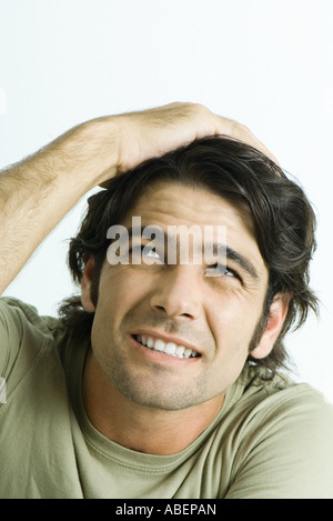 Cropped young european man suffering from knee pain, presses hand to ...