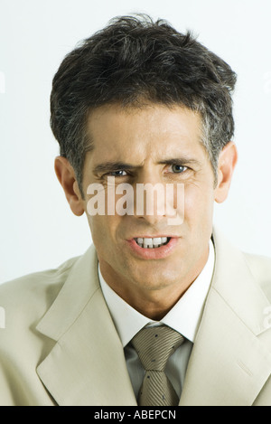 Portrait of businessman with frowning brows Stock Photo - Alamy