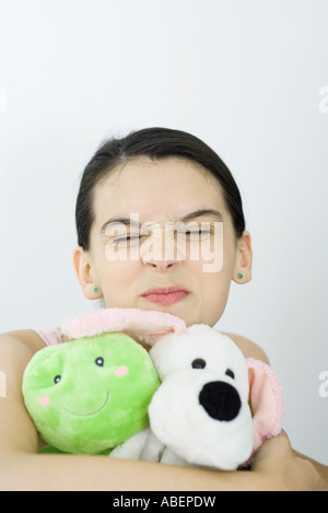 Teen girl holding stuffed animals, portrait Stock Photo - Alamy