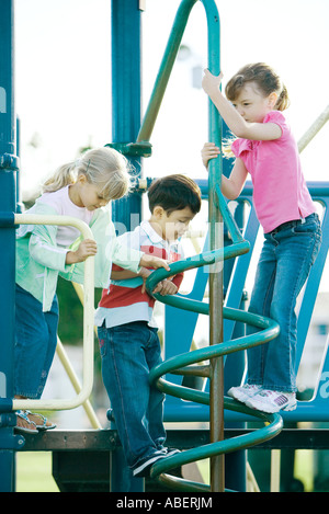 Child Girl climbs on a pole at the playground, sliding, kid playing ...