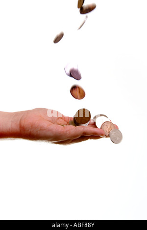 Coins falling from an open hand Stock Photo - Alamy