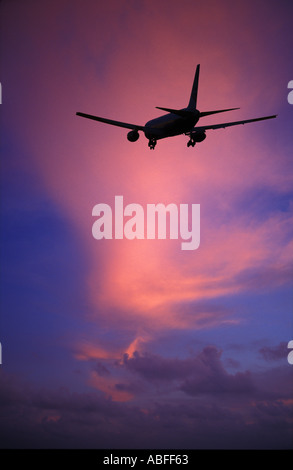 Low angle view of airplane landing in cloudy sky Stock Photo - Alamy