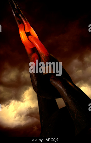 HEAVY STEEL CHAIN WITH GLOWING RED LINKS HANGING FROM STORM CLOUDS IN ...