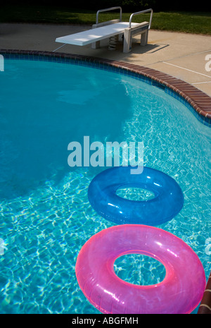 Diving board and inflatable ring in a pool Stock Photo - Alamy