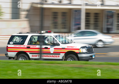 Fire department s Shift Commander car driving on a city street in ...