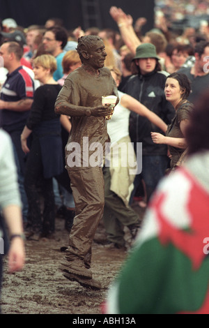 Men covered in mud and dancing to music in Woodstock 94, Saugerties ...
