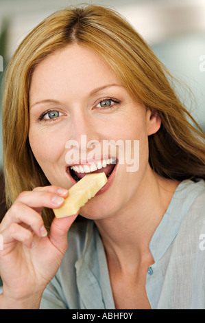 Woman eating gruyere Stock Photo - Alamy