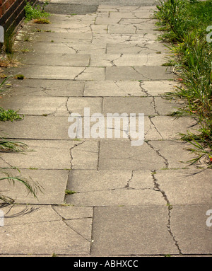 Cracked and damaged paving slabs on a public footpath making them a ...
