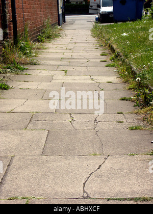 Cracked and damaged paving slabs on a public footpath making them a ...