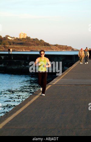 Woman running on a jetty in Victoria Stock Photo - Alamy