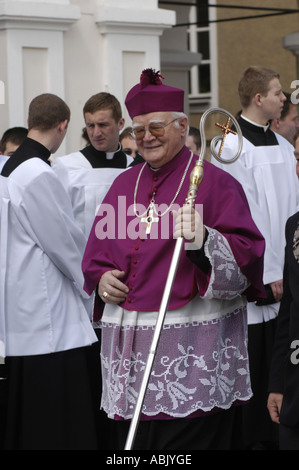 Roman Catholic bishop in purple and white dress holding a crosier ...