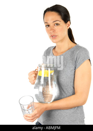 Young woman pouring water into glass on blue background Stock Photo - Alamy