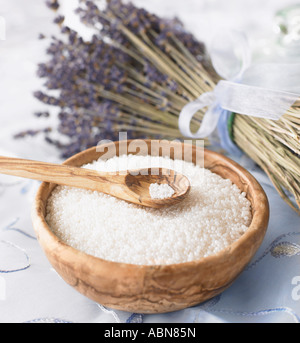 Spa products. Lavender bath salts with flowers and towel. Violet purple ...