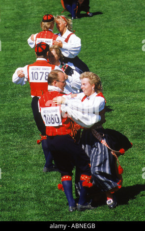 Couples in traditional Swedish folk costumes parade at midsummer ...