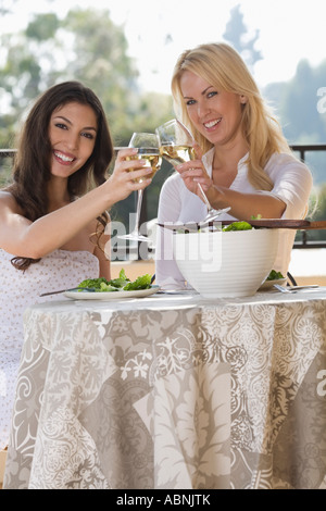 Beautiful woman and her best friends toasting with a refreshing drink ...