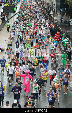 Marathon runners running at public city marathon. Marathon runners and ...