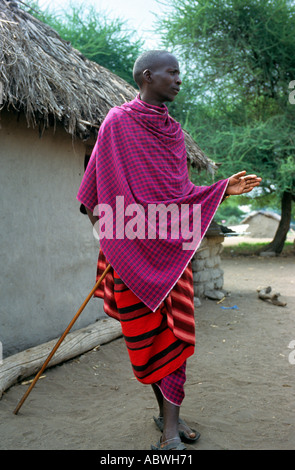 A man dressed in cultural nomadic clothes is in the field. Camel ...