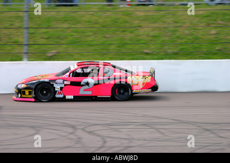 V8 Nascar type stock cars racing on a banked oval circuit Stock Photo ...
