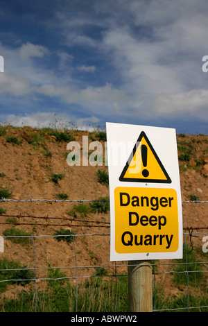 Danger sign near a quarry warning of a cliff edge Stock Photo - Alamy