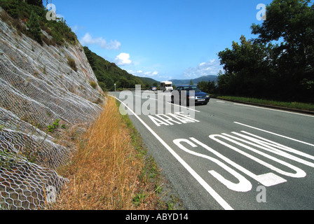 Near Barmouth roadside cliff face covered in heavy wire netting to help ...