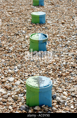 Wooden bollard on pebble beach Stock Photo - Alamy