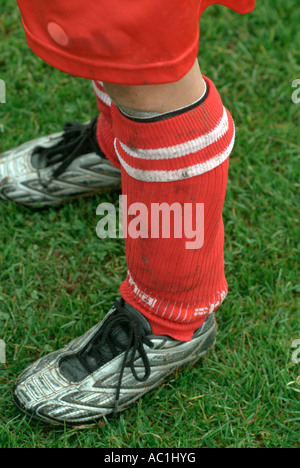 Legs of a male football player on soccer ball at stadium, close up ...