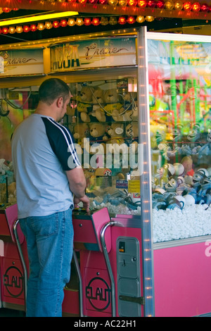 Fairground grab machine filled with cuddly toys Stock Photo - Alamy