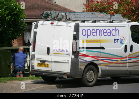 A BT Openreach communications engineer working on a telephone line box ...