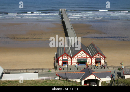 Saltburn pier and amusement arcade at low tide with cliff lift tram ...