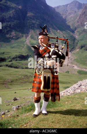 Scottish Piper playing the bagpipes at Glencoe in Scotland Stock Photo ...