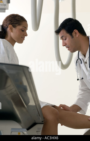 Portrait of doctor examining patient's leg Stock Photo - Alamy