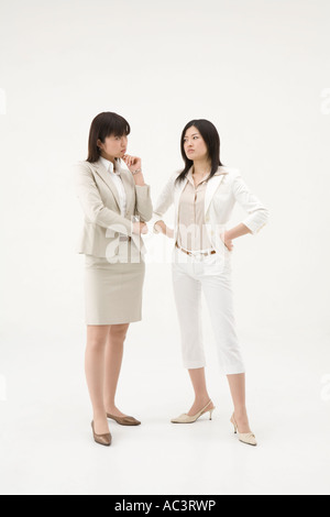 Two businesswomen glaring at each other Stock Photo - Alamy