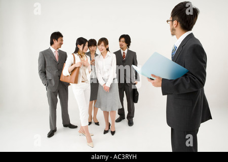 Businessman excluded from group of business people Stock Photo - Alamy